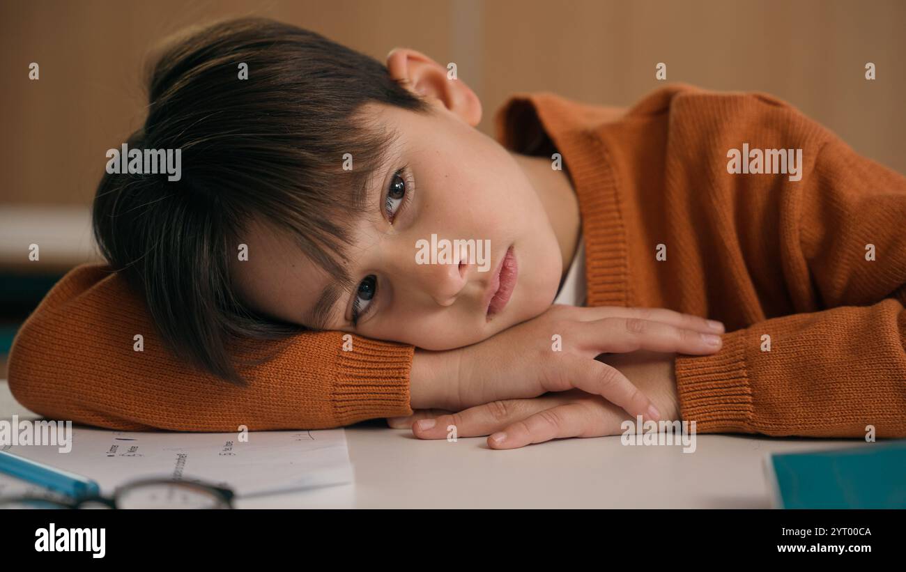 Caucasian bored schoolboy sleepy at school elementary education study ...