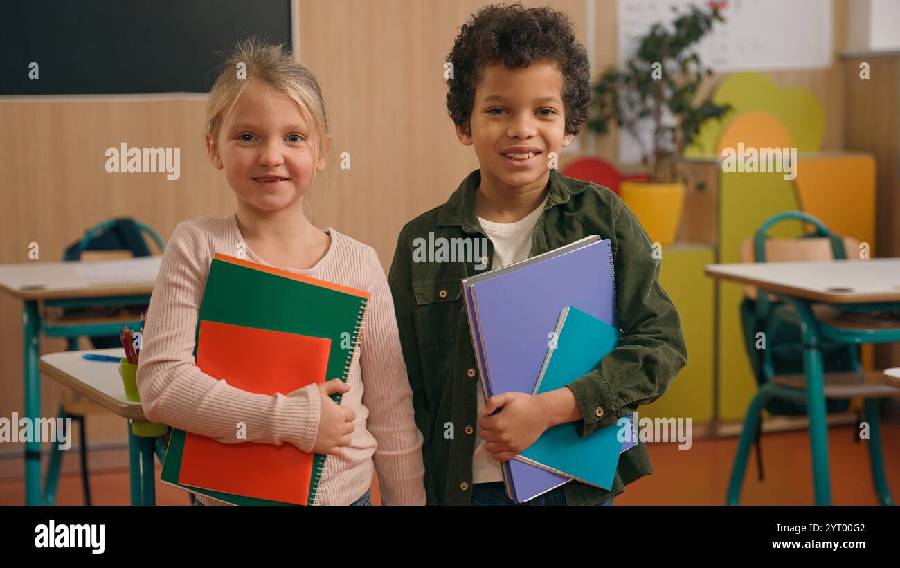 Two smiling happy multiracial diversity children school kids ...