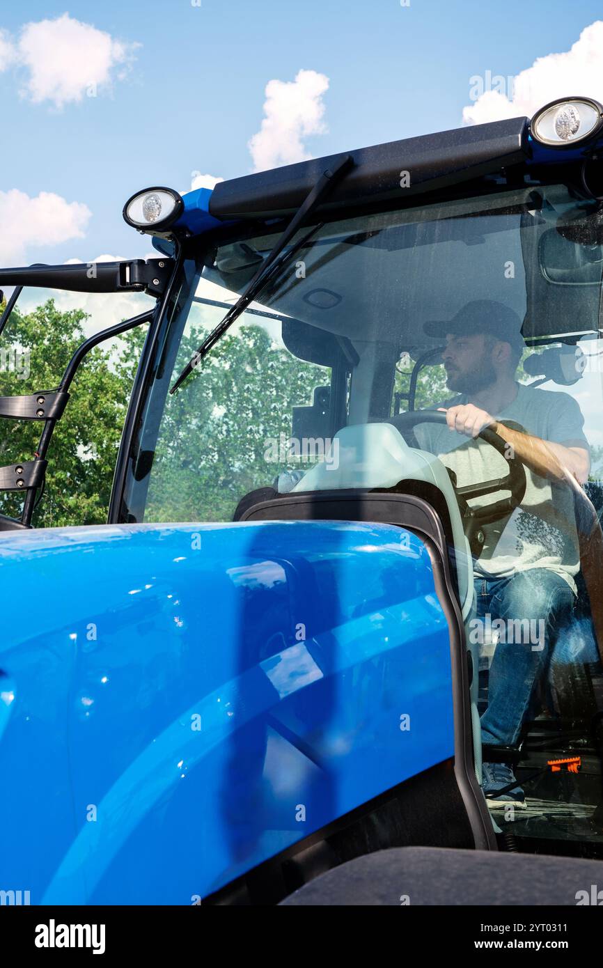 Farm working operating agricultural tractor in countryside Stock Photo ...