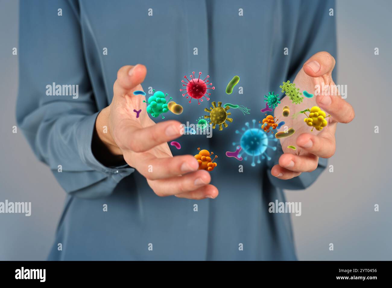 Man showing hands with microbes on grey background, closeup ...