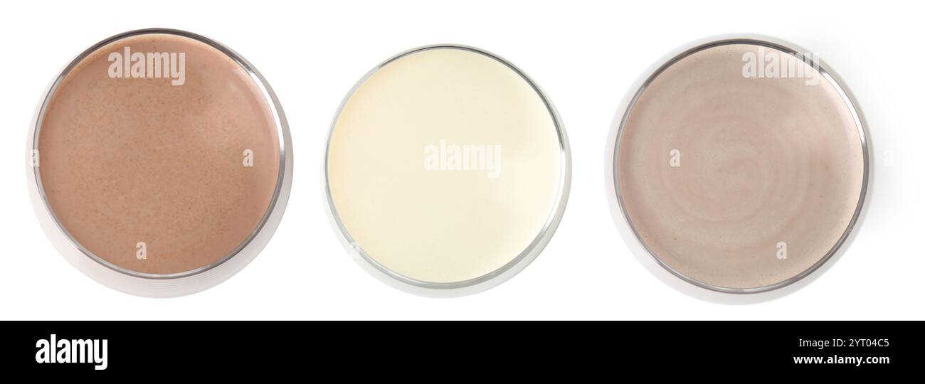 Protein shakes of different flavors in glasses isolated on white, top ...