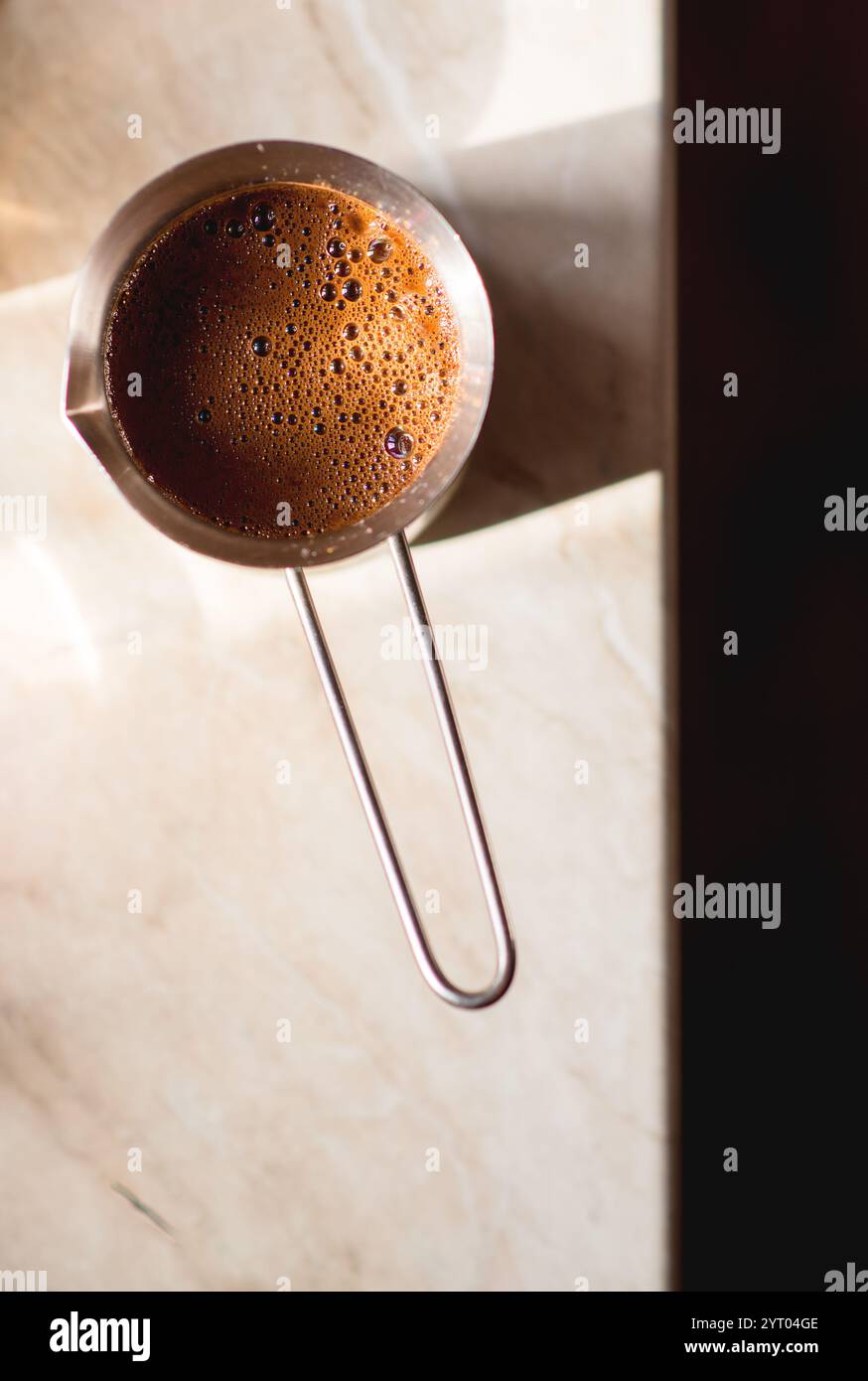 ready-made turkish coffee in a cezva in a turk on the table top view ...