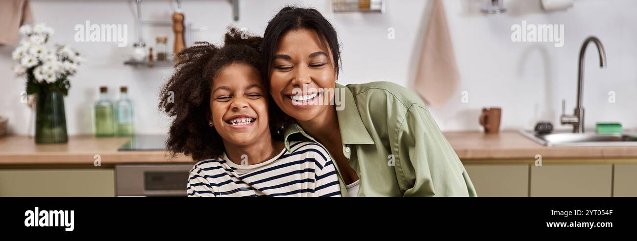 Laughter fills the air as a happy mother and her daughter enjoy quality time together Stock ...