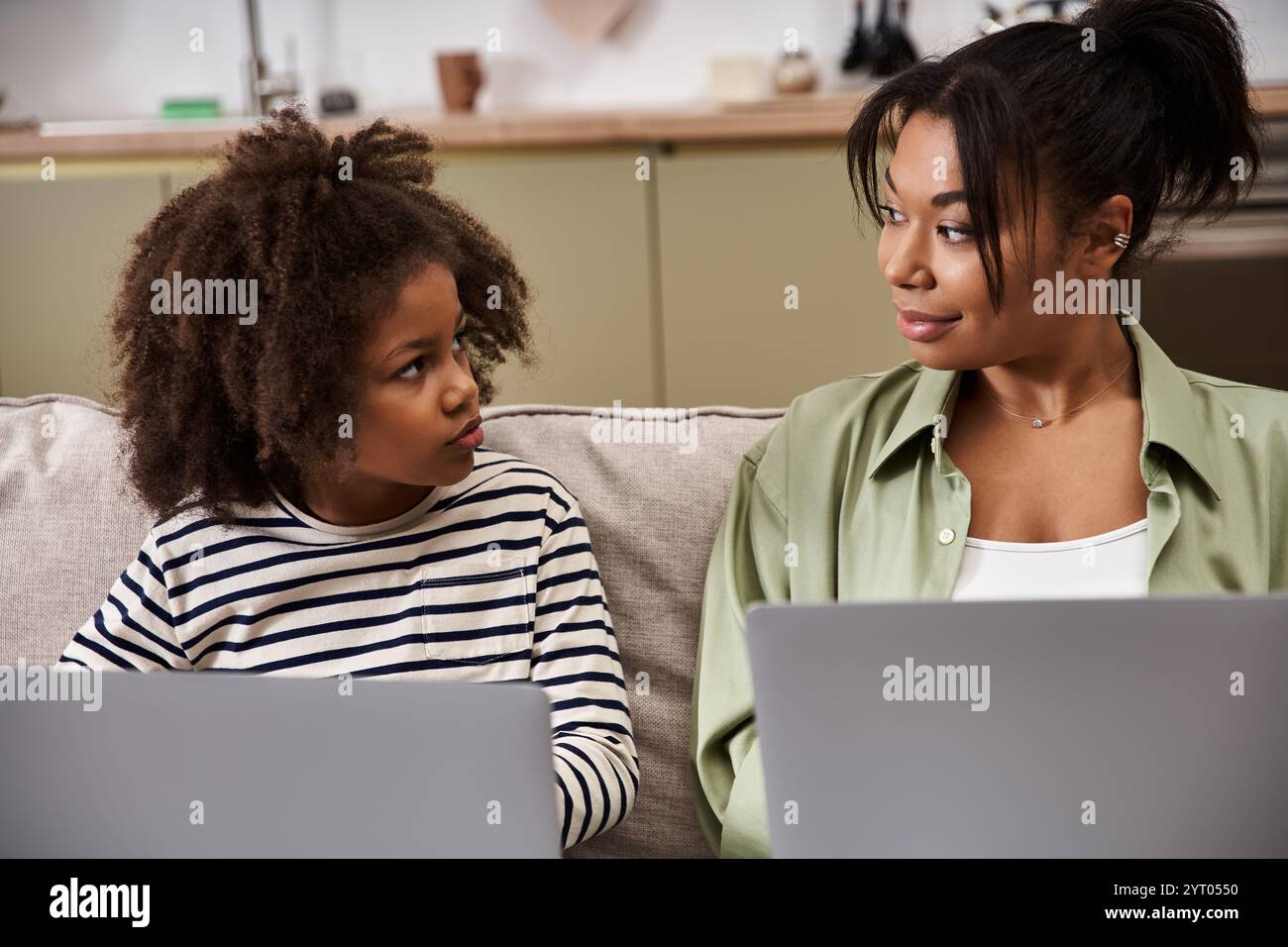 Two family members engage in activities together at home, embracing ...