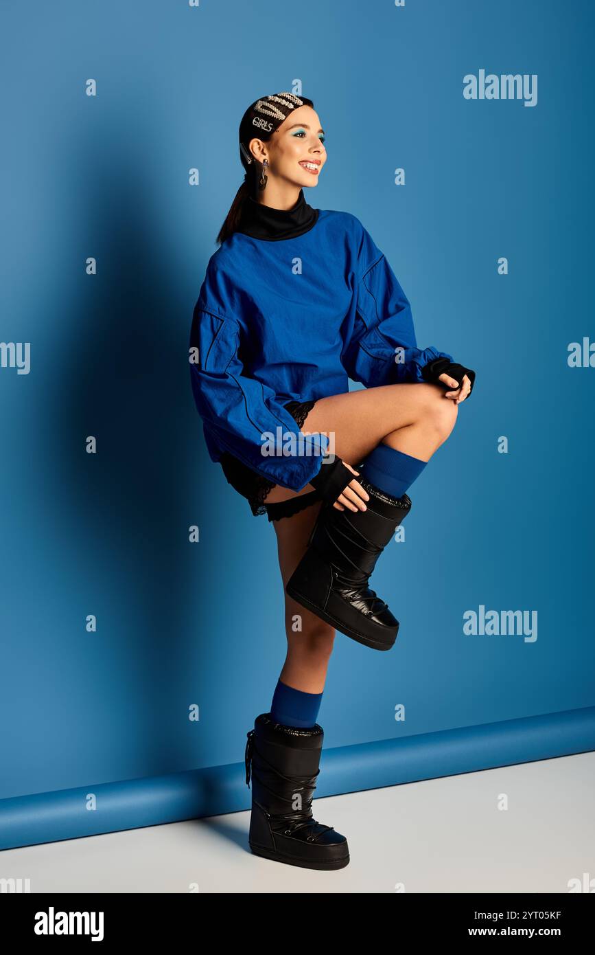 A fashionable young woman poses playfully in stylish attire and hair ...