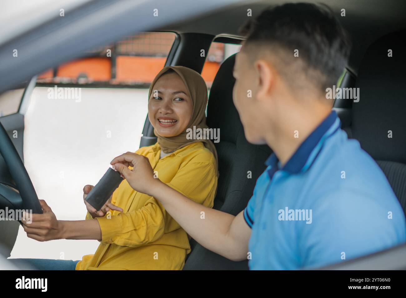Joyful Interaction Inside a Car A Young Couple Sharing a Special Moment ...