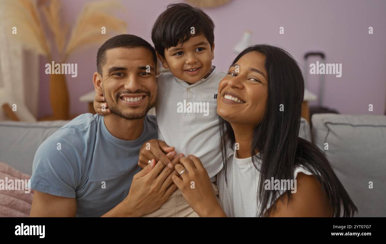 Happy family with man, woman, and child smiling together in the living ...