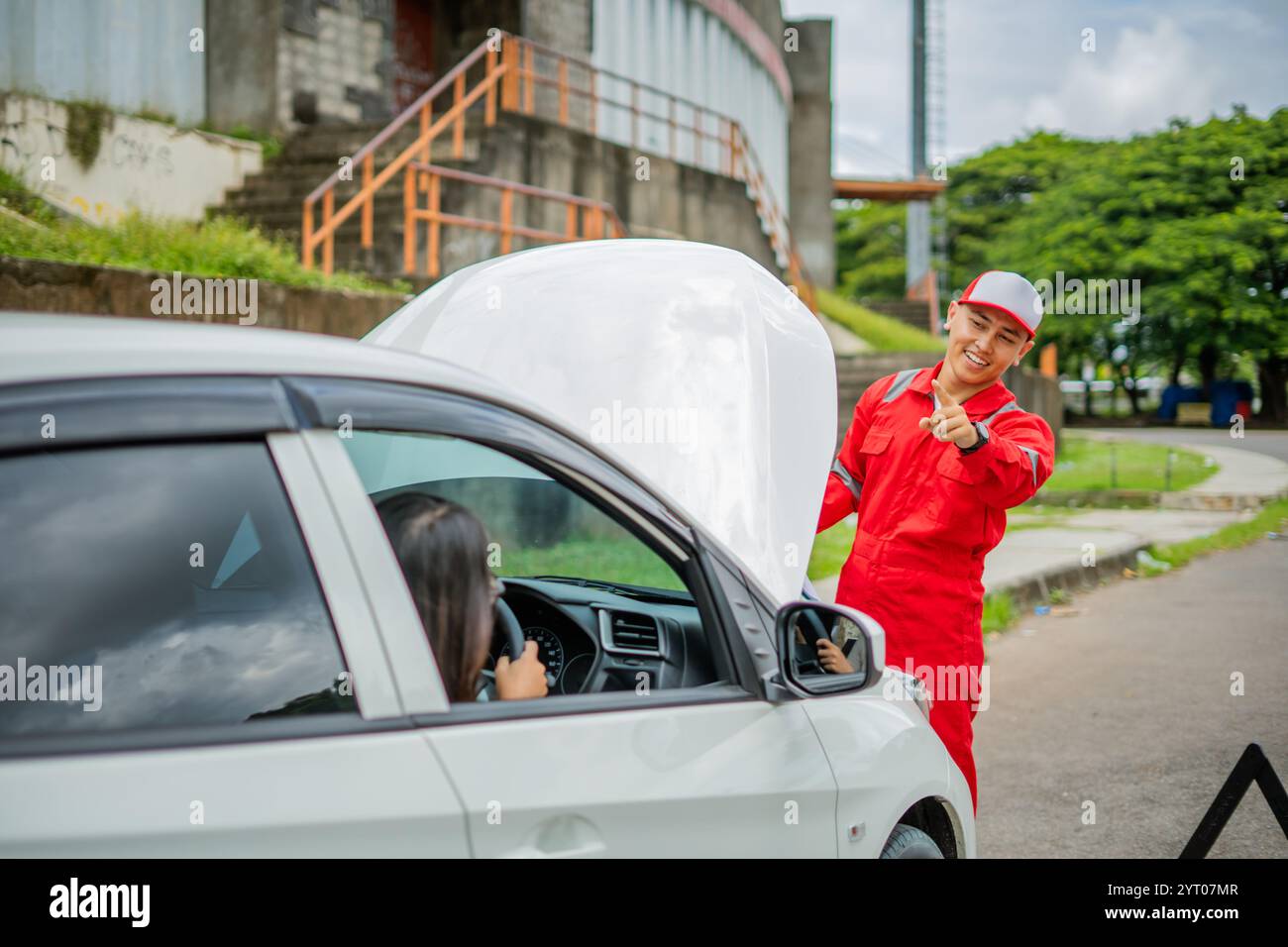 Car Breakdown Assistance: Mechanic Helping Driver with Engine Troubles Stock Photo - Alamy