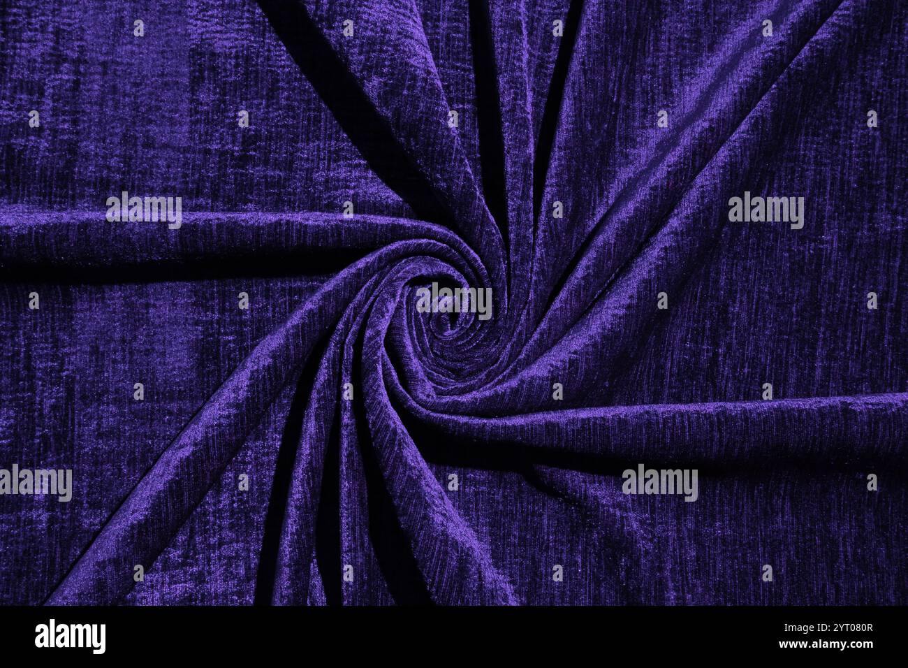 A beautiful sample of velvet fabric of dark blue twisted in a spiral ...