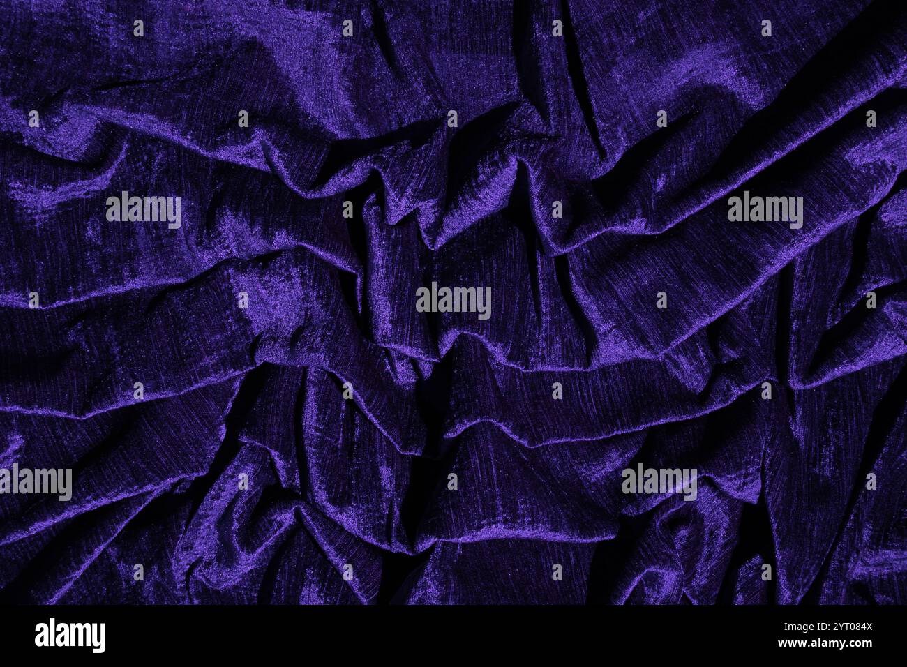 Soft waves of velvet fabric in dark blue, a deep saturated shade of the ...