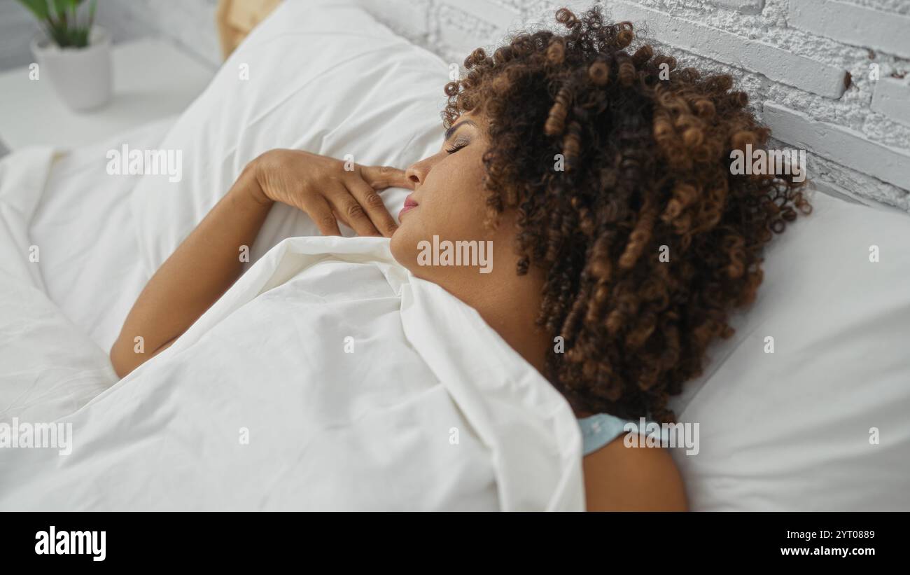 Hispanic woman sleeping in bed hi-res stock photography and images - Alamy