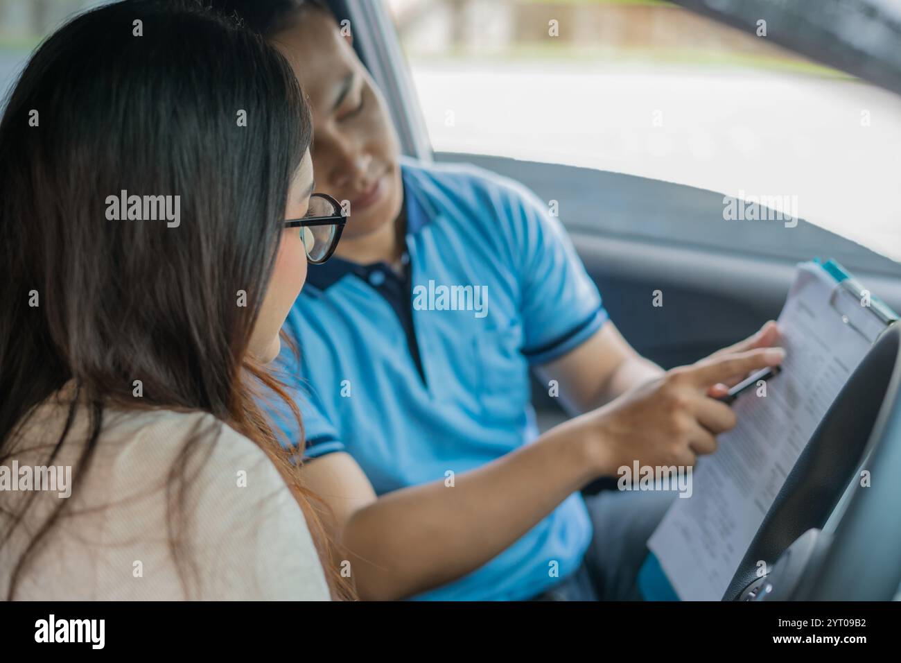 Driver and Student Engaging in Pre-Driving Instruction Inside a Vehicle ...