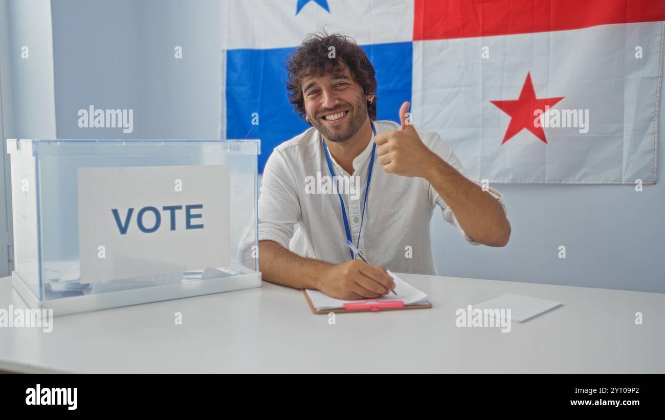 Young man in an electoral room giving a thumbs up while sitting at a ...