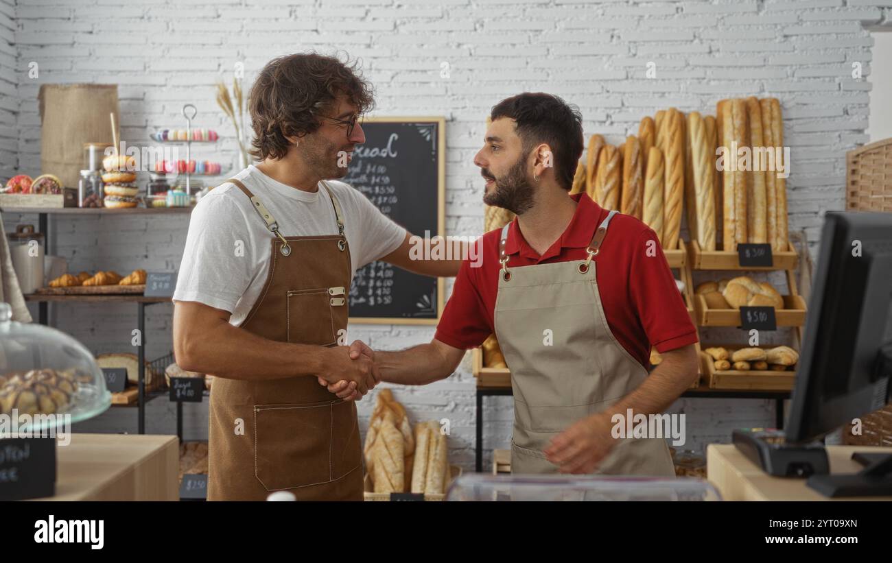 Two male bakers shaking hands in a cozy bakery interior with loaves of ...