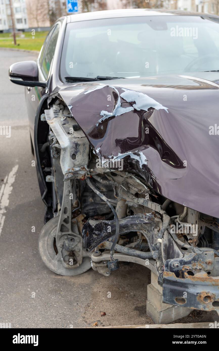 A passenger car is parked in the parking lot with damage to the right ...