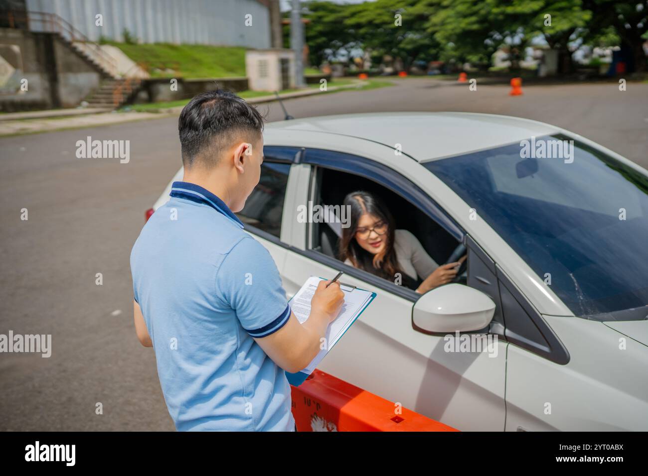 Driving Lesson in Progress The Instructor is Evaluating the Student ...