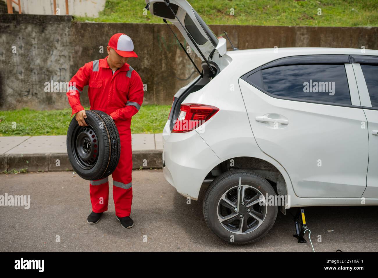 Professional Mechanic Changing Tire on Roadside Assist Service Vehicle ...