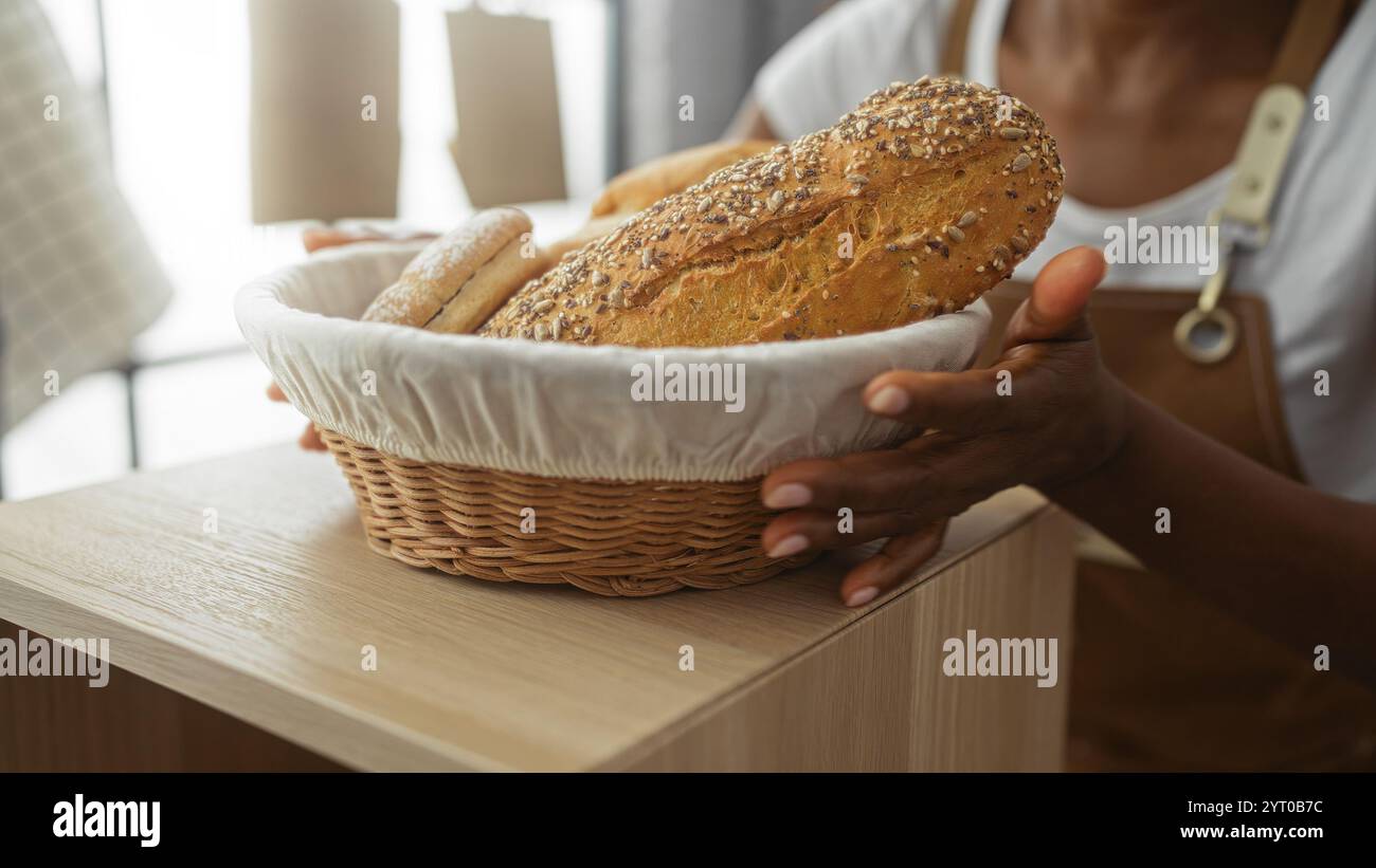 African american woman holding a basket of freshly baked bread in a ...