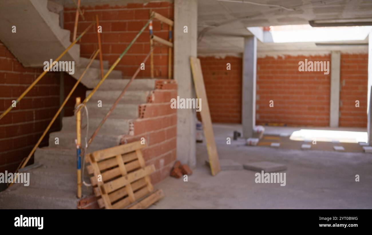 Blurry image of an unfinished construction site with brick walls ...