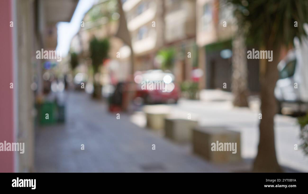 Blurred city street scene with colorful buildings and parked cars ...