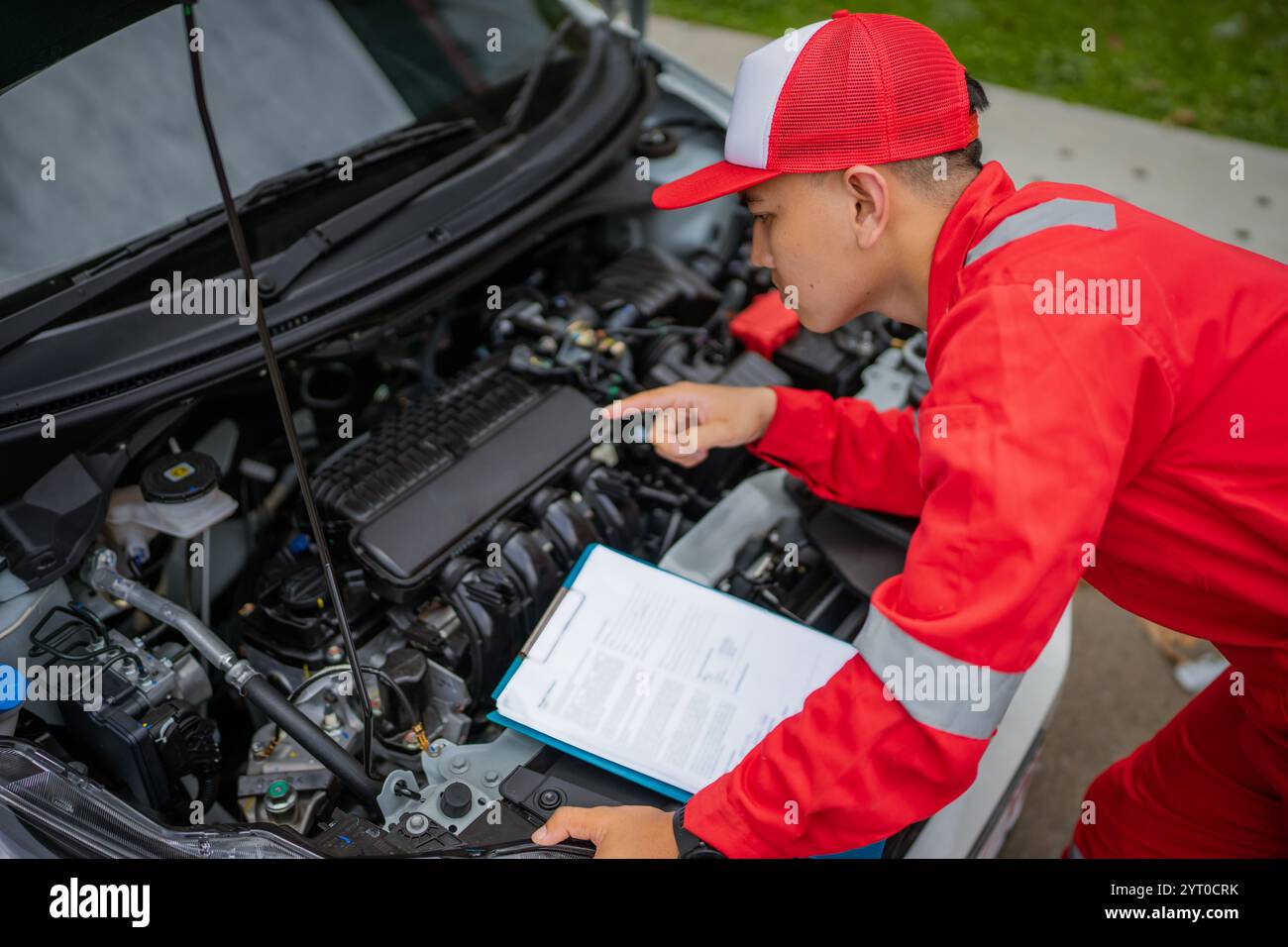 A Young Mechanic Conducts a Thorough Engine Inspection While Using a ...