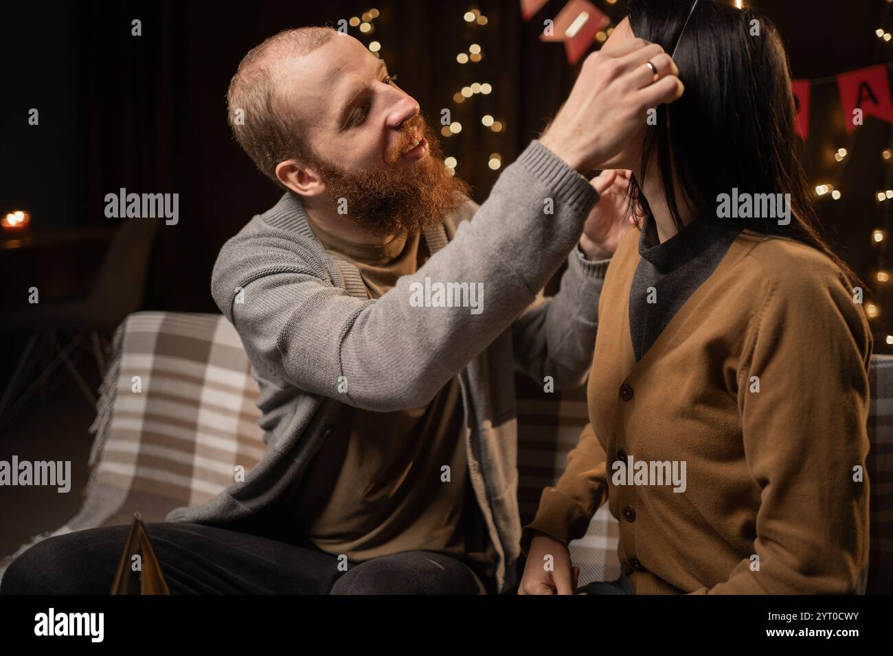 Young couple preparing to celebrate birthday party at home. Husband ...