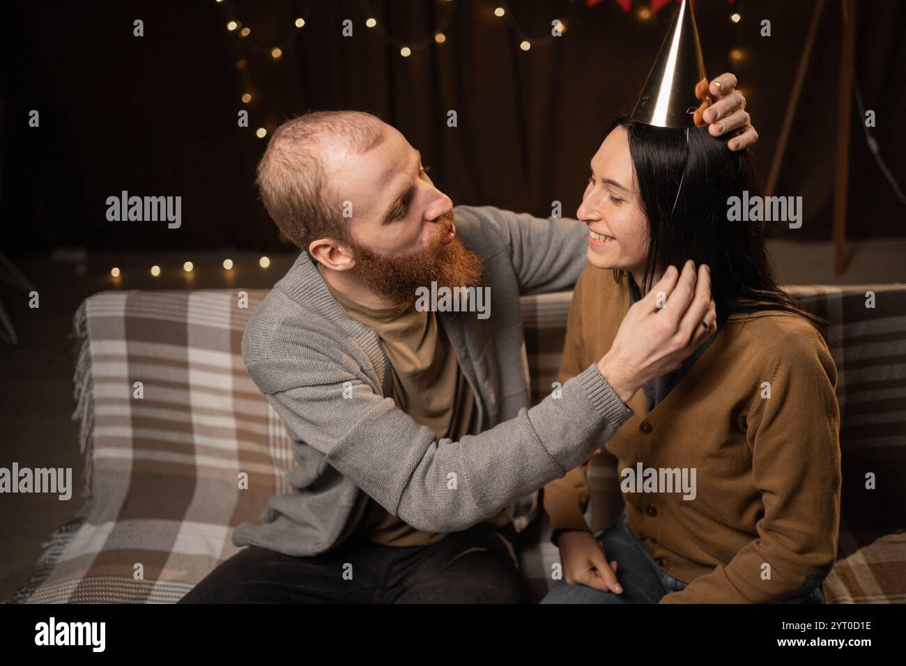 Young couple preparing to celebrate birthday party at home. Husband ...