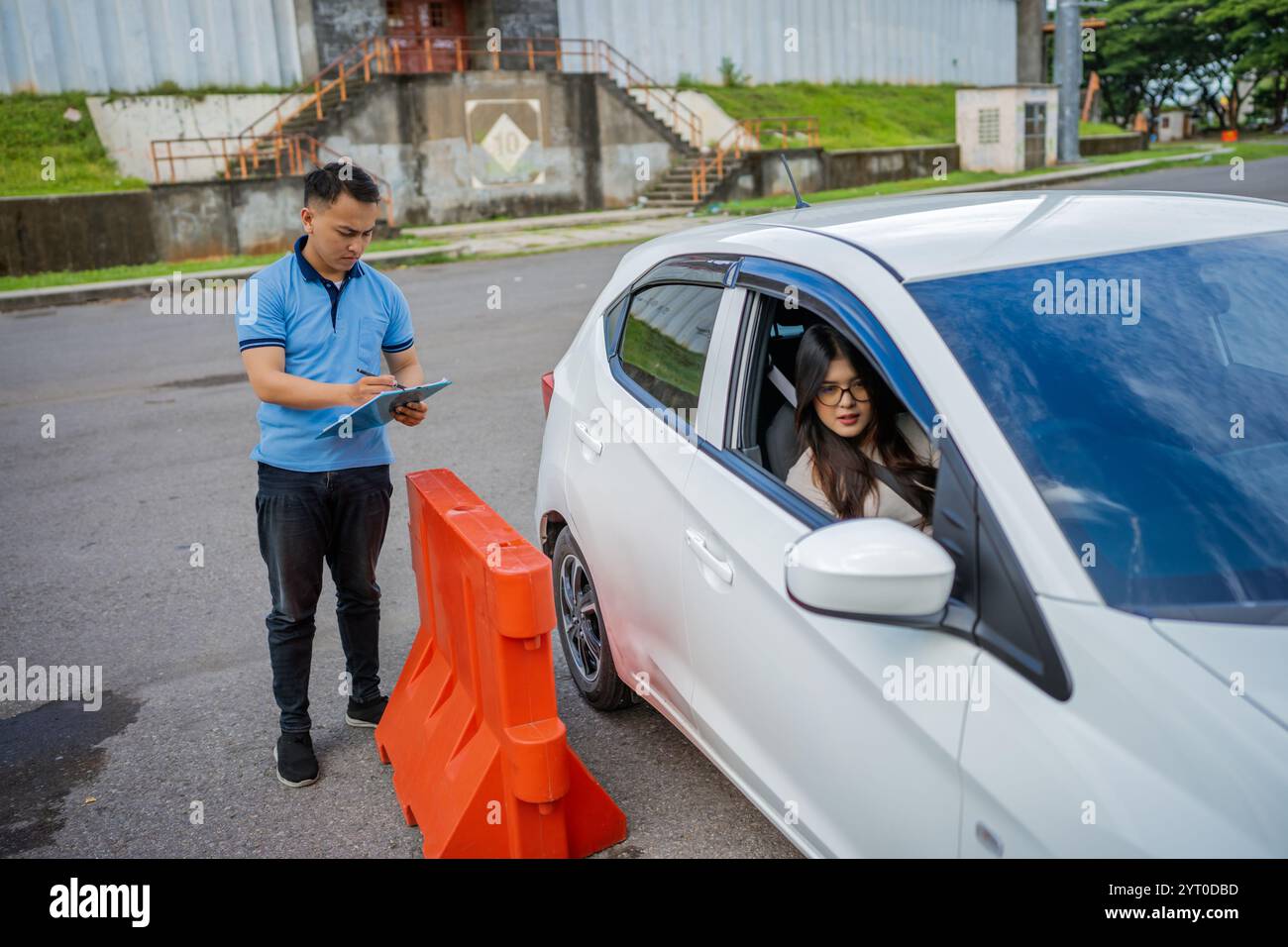 A traffic officer checks a drivers details at a control checkpoint for ...