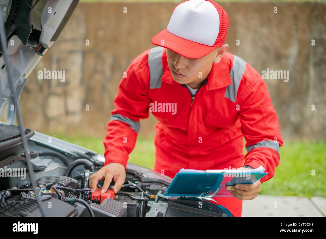 An Automotive Technician is Performing Essential Maintenance on a Car ...