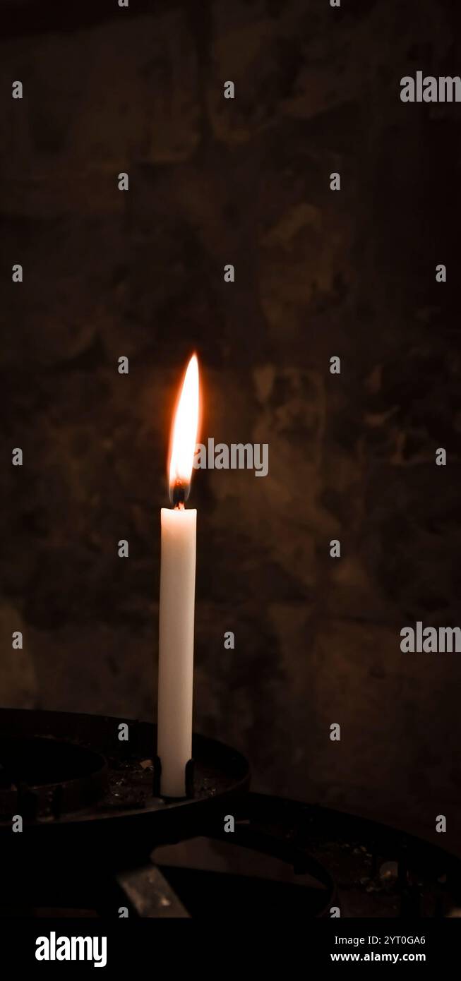 Candle in church (against rough stone wall background Stock Photo - Alamy
