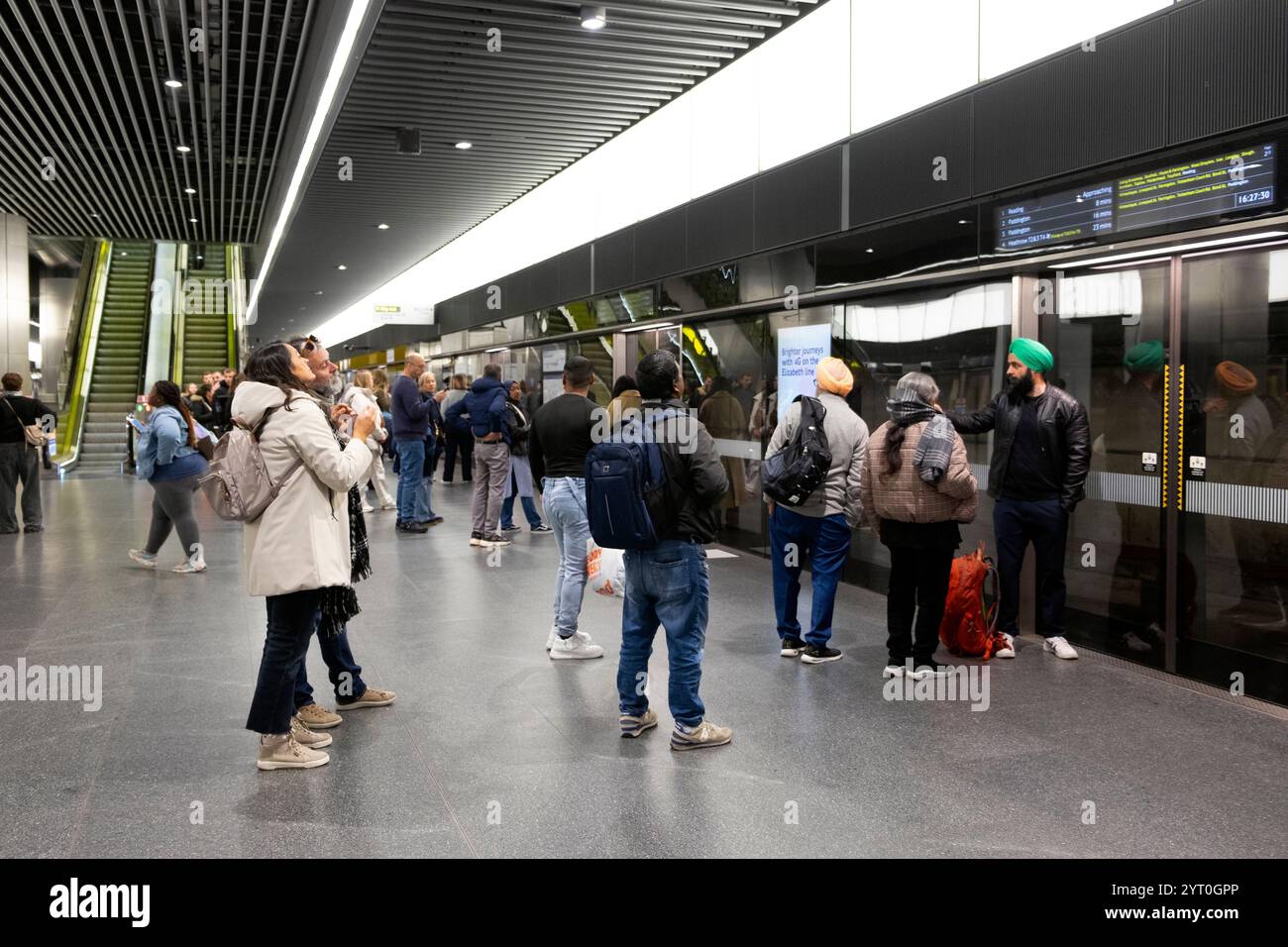 Passengers people waiting on platform to board train at Elizabeth Line ...