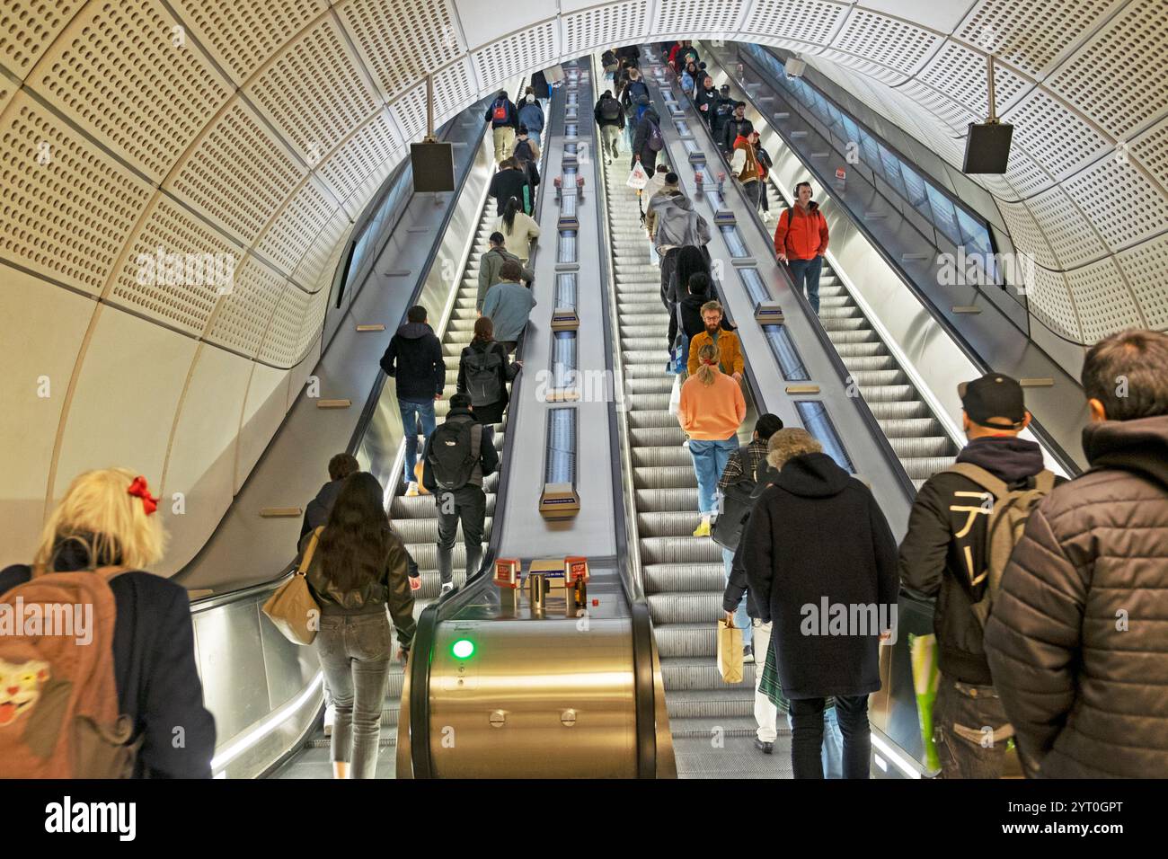 Passengers people standing riding on Elizabeth Line escalator at ...