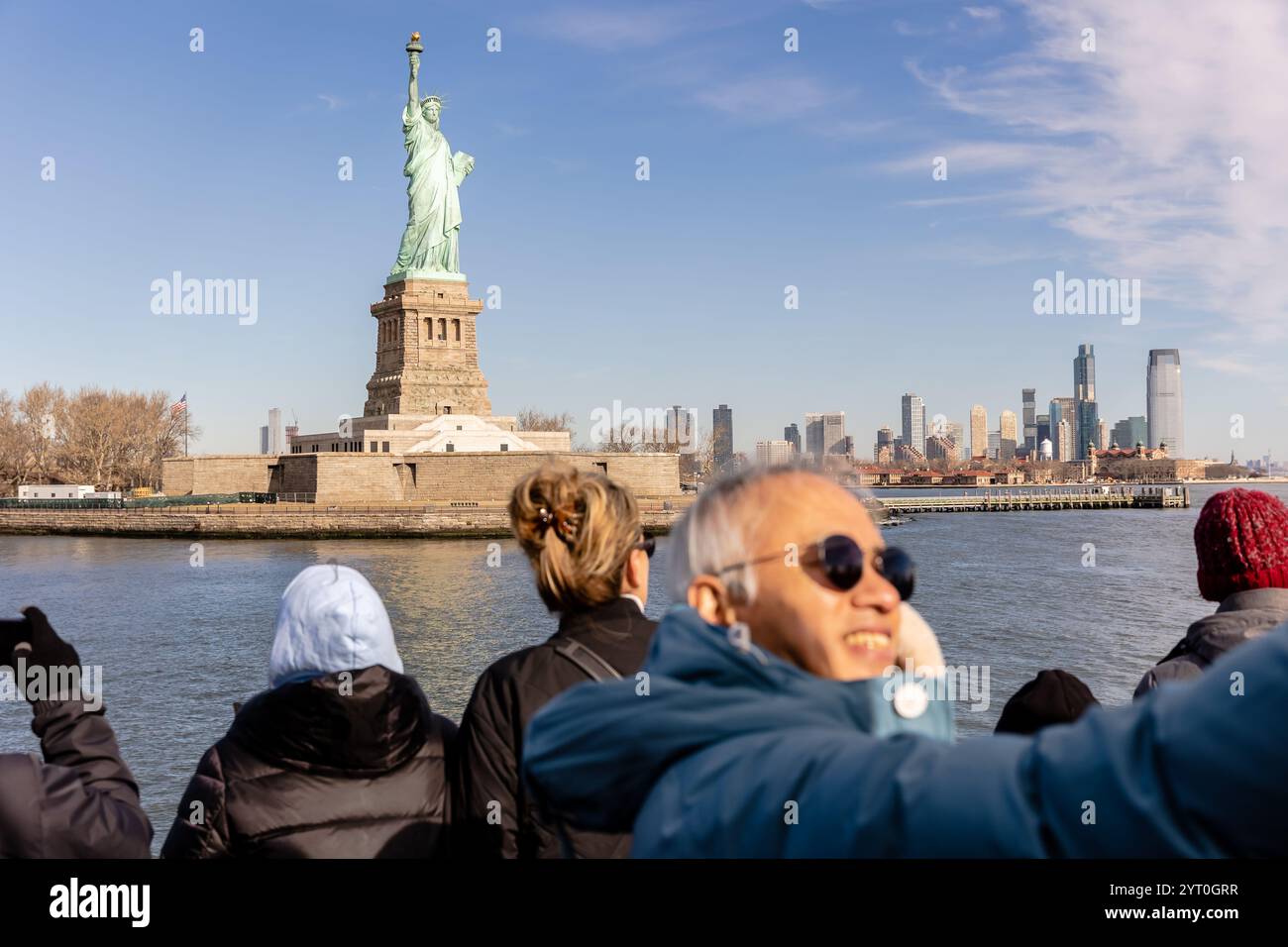 New York City, USA - February 13, 2023 - Tourists taking photos of the Statue of Liberty aboard ...
