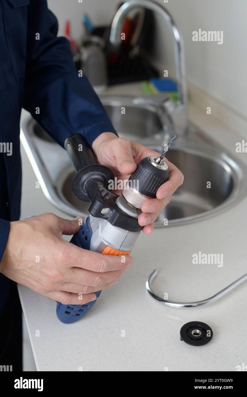 Handyman plumber fixing plumbing kitchen sink hi-res stock photography ...