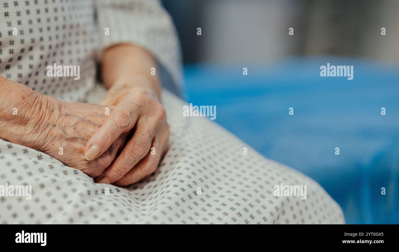 Hands of old woman with serious health issues sitting on hospital bed ...