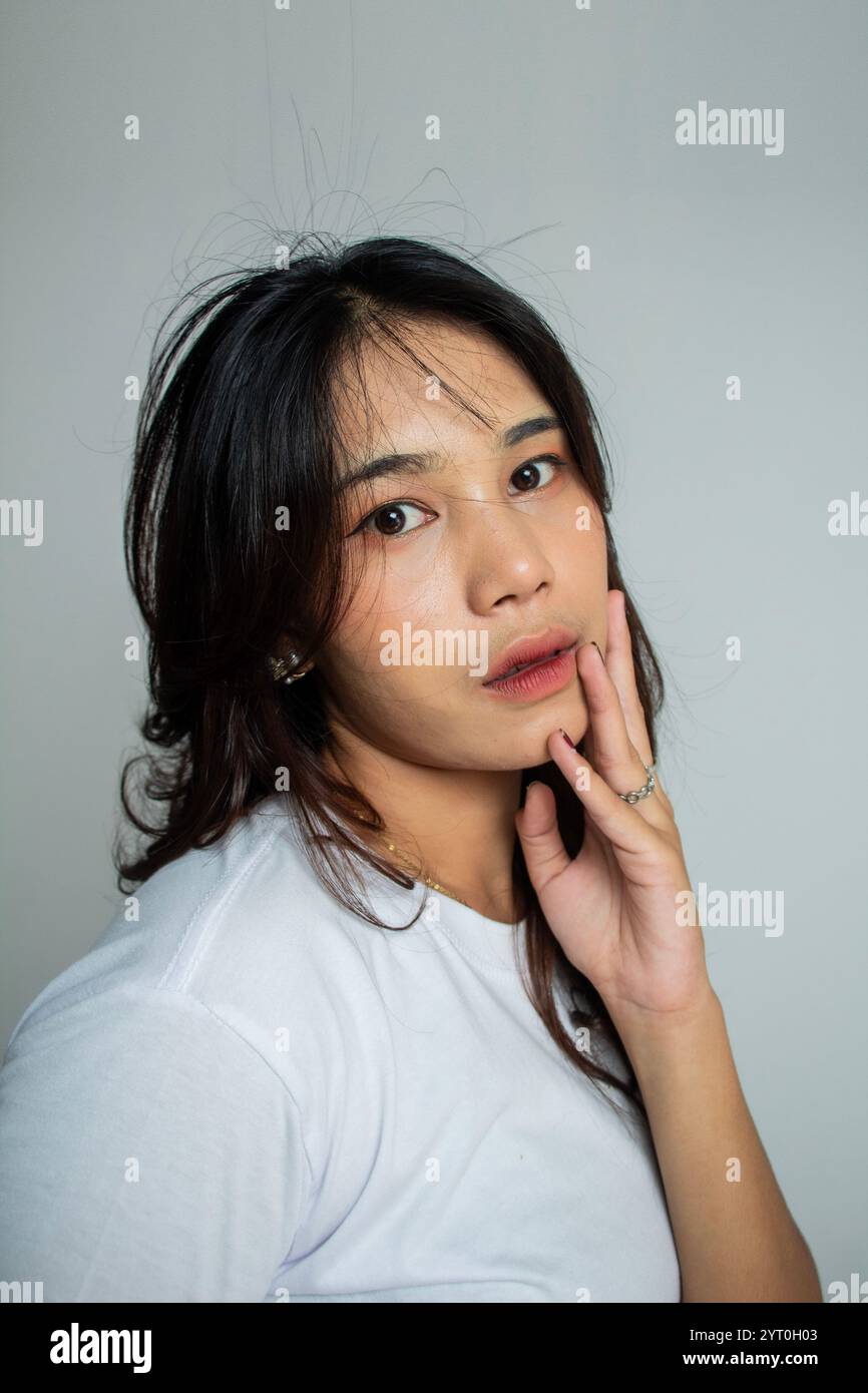 fashion portrait of young asian face without makeup with hand on her ...