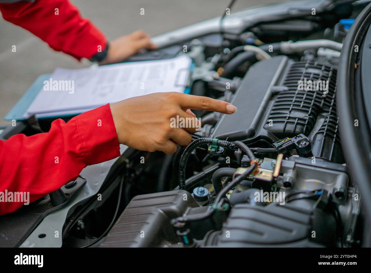 A mechanic is conducting a thorough inspection on a vehicle engine ...