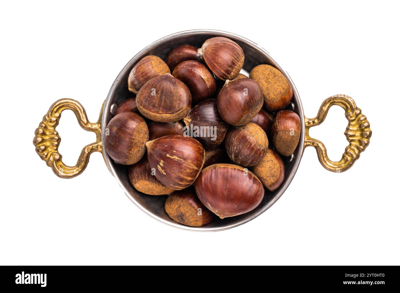 Raw chestnuts in rustic skillet ready for cooking isolated on white ...