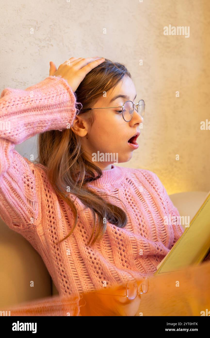 Surprised teenage girl reading a book. Emotion concept Stock Photo - Alamy