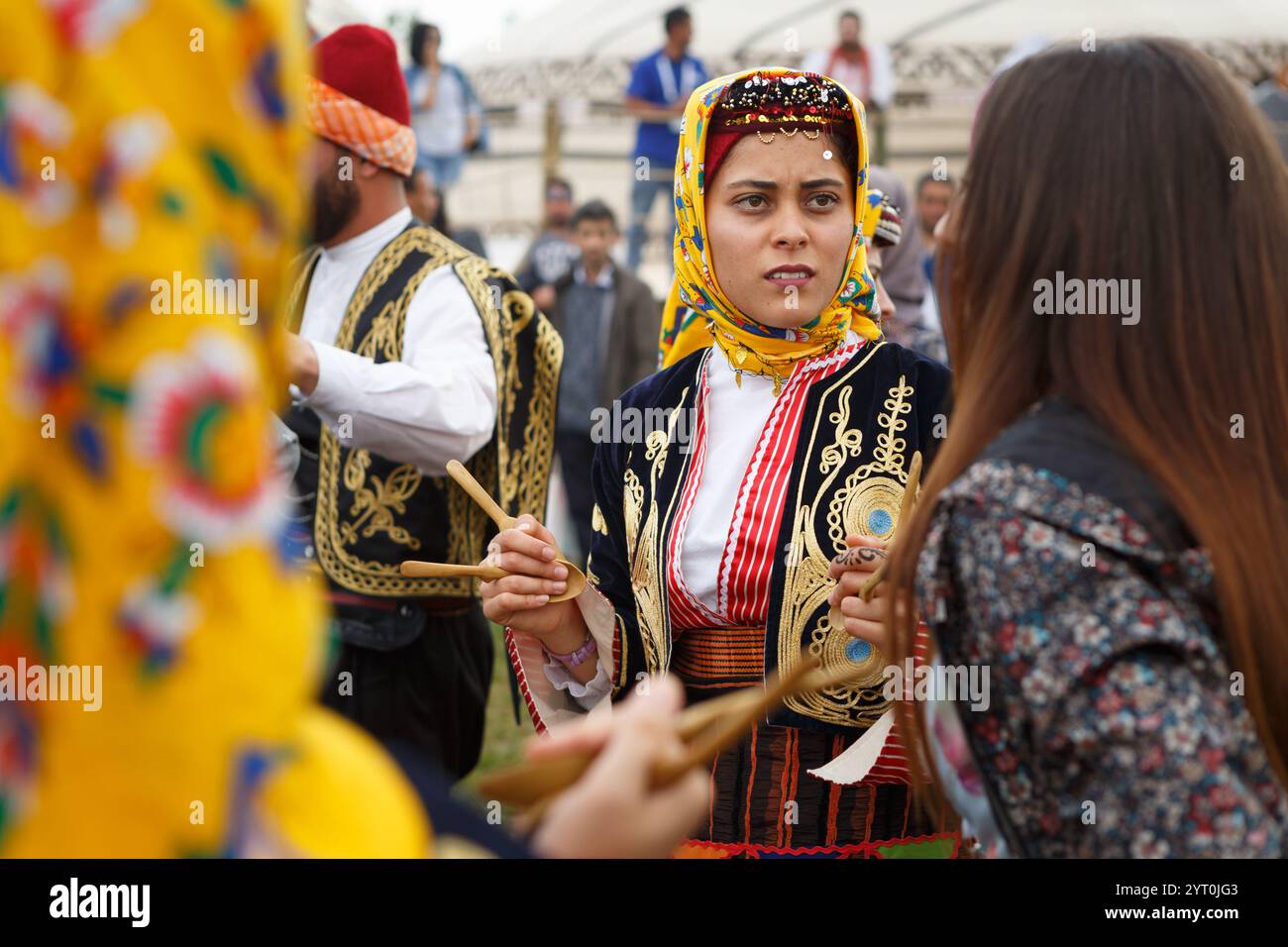 Turkish woman dancing dressed in traditional dress with wooden spoons ...