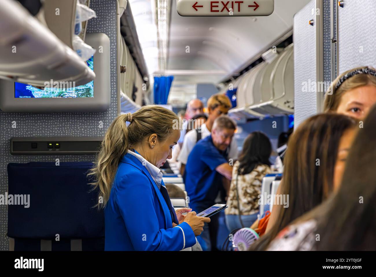 Cabin crew and passengers on board KLM flight from Amsterdam Stock ...