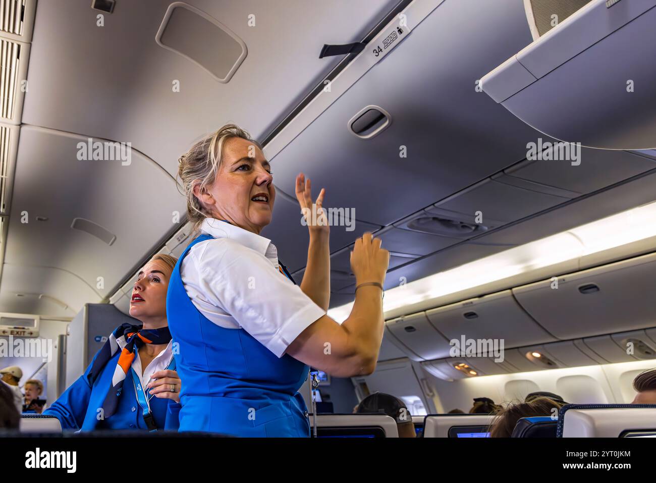 Cabin crew and passengers on board KLM flight from Amsterdam Stock ...
