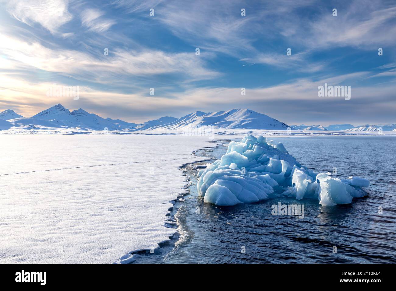Blue glacial iceberg at the edge of the fast ice, Nordfjorden fjord ...