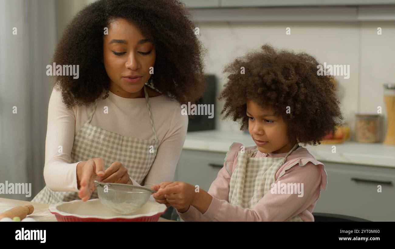 African American family cooking together mother woman mom teach little ...