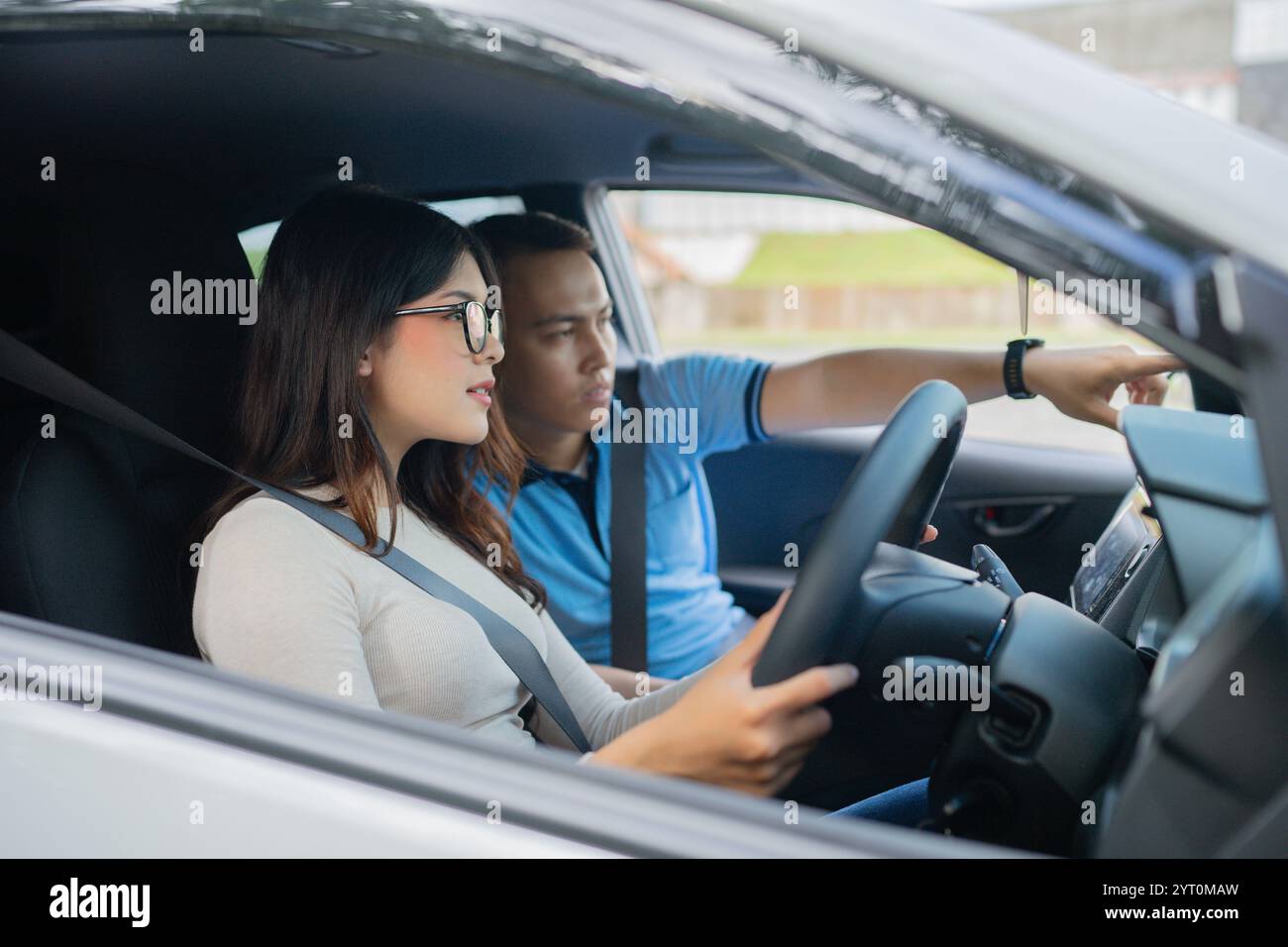 A Young Couple Engaging in Driving Lessons Inside a Stylish Modern Car ...