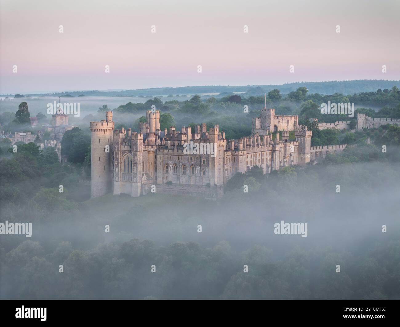 Aerial view of Arundel Castle at dawn on a misty summer morning ...