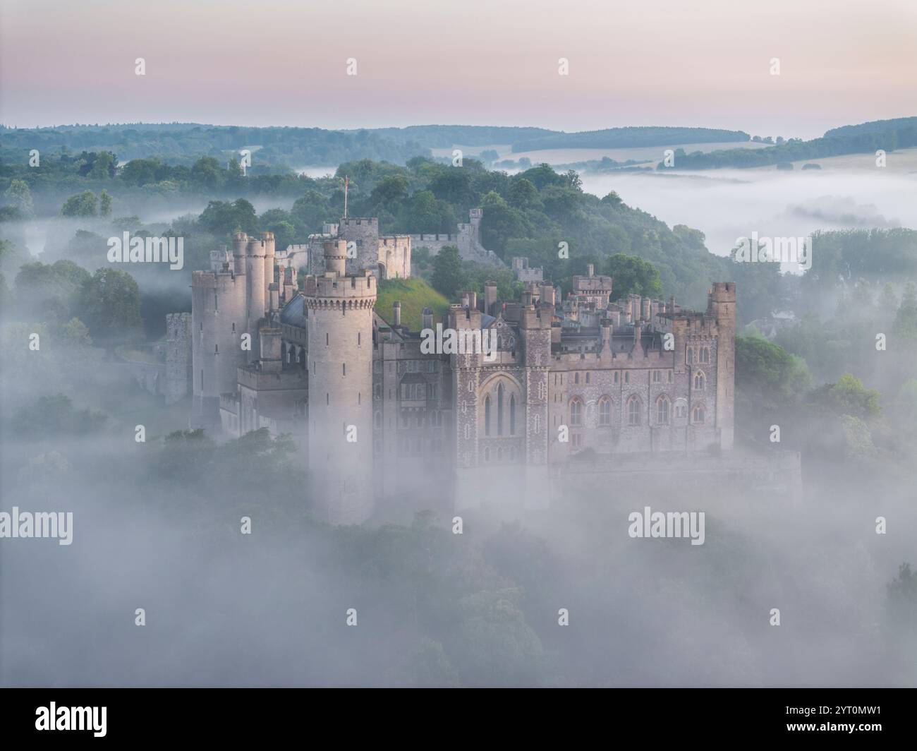 Aerial view of Arundel Castle at dawn on a misty summer morning ...