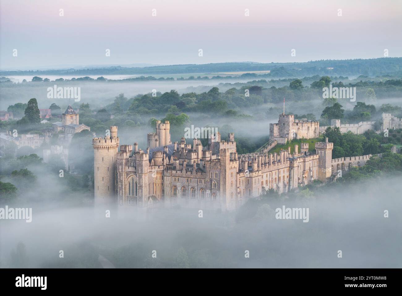 Aerial view of Arundel Castle at dawn on a misty summer morning ...