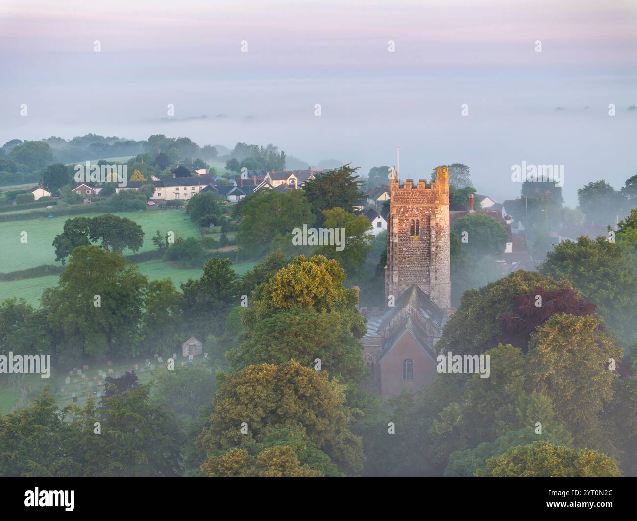 St Mary's Church emerging from morning mist at sunrise, Morchard Bishop ...