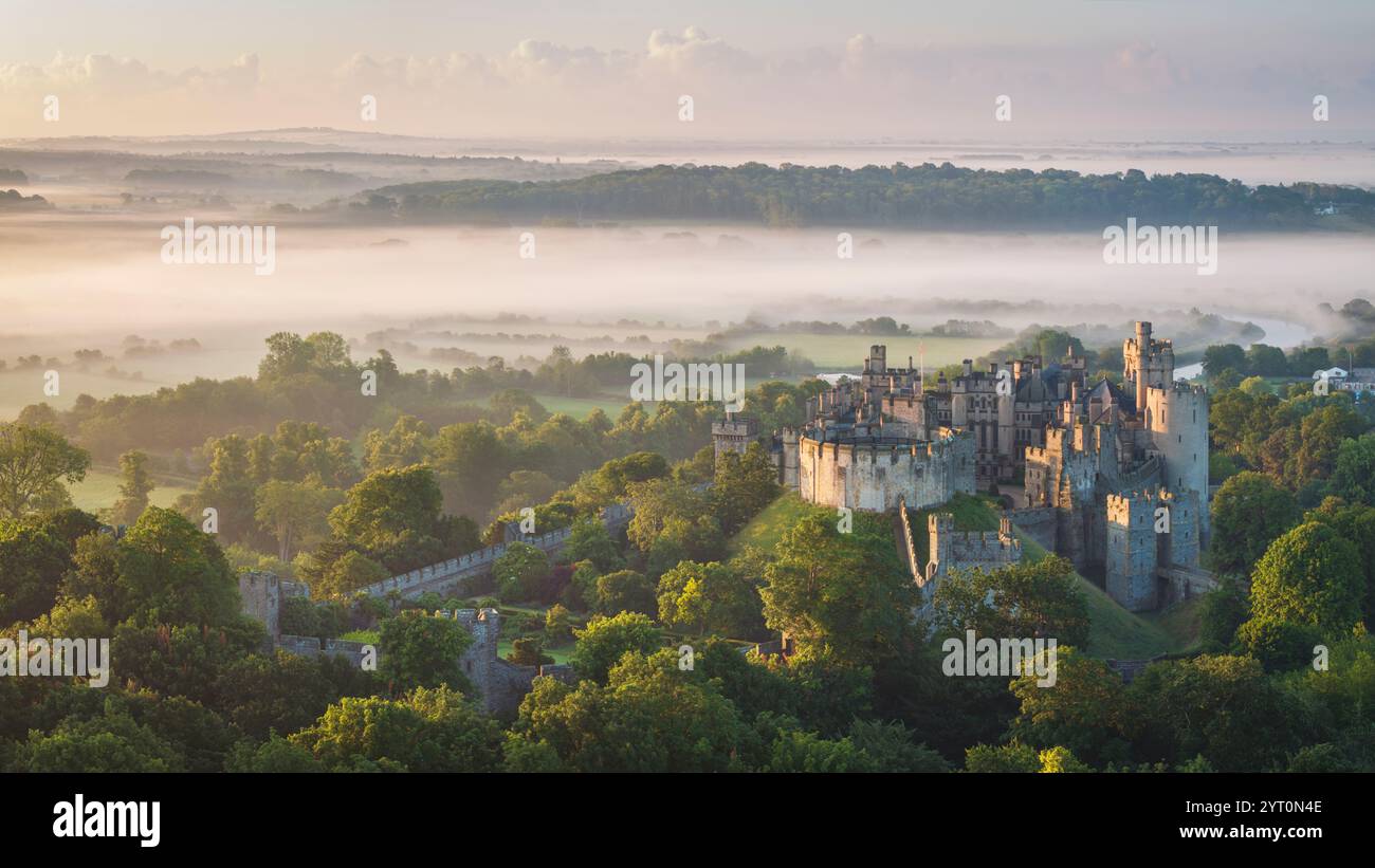 Aerial view of Arundel Castle at dawn on a misty summer morning ...